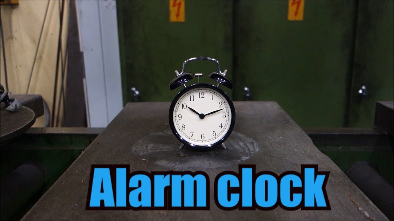 Crushing alarm clock with hydraulic press